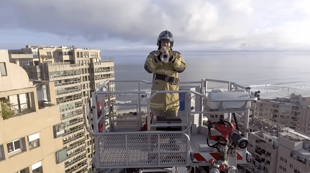Brazilian Firefighter Plays Trumpet For Quarantined Residents - InspireMore
